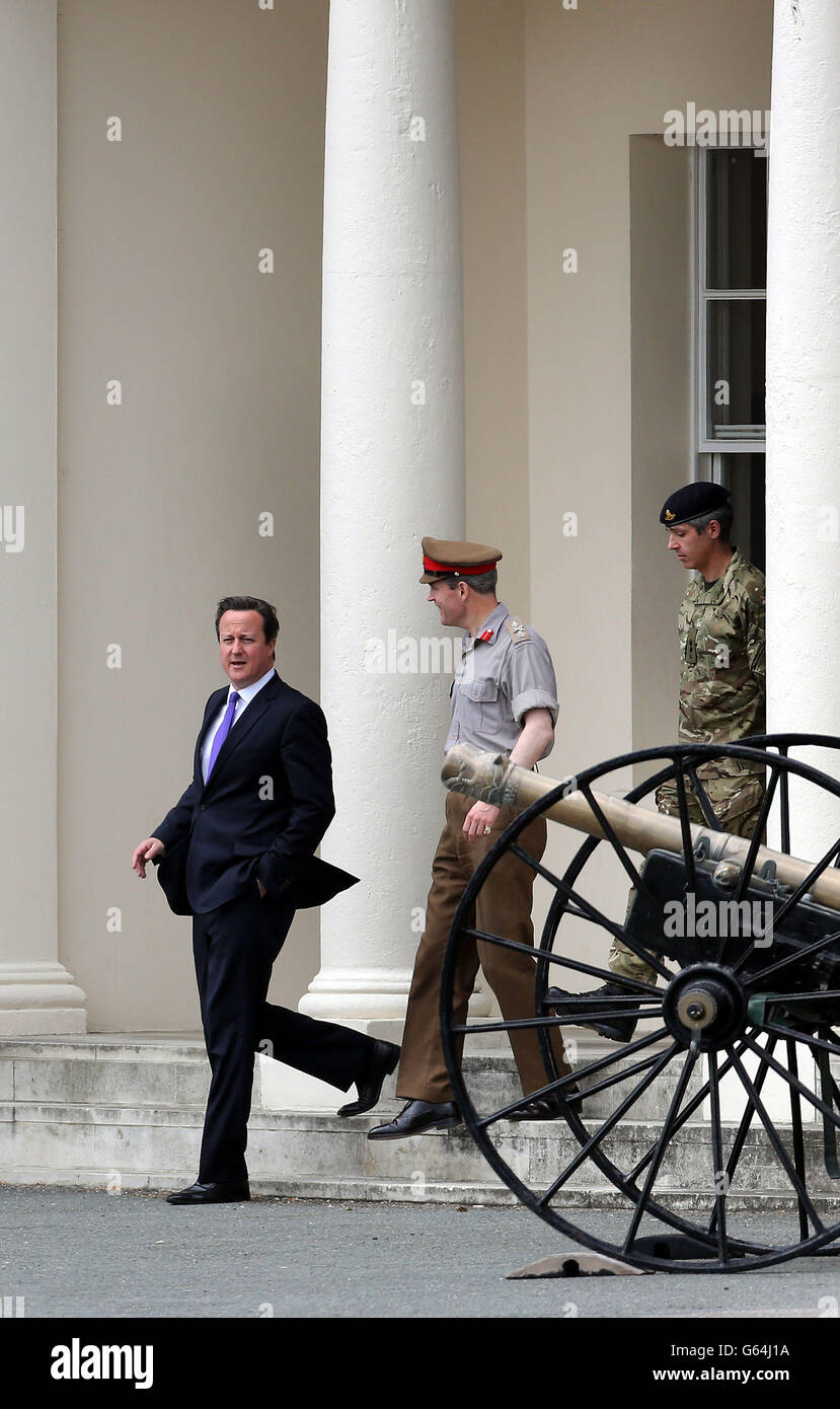 Prime Minister David Cameron leaves Woolwich Barracks in London ...