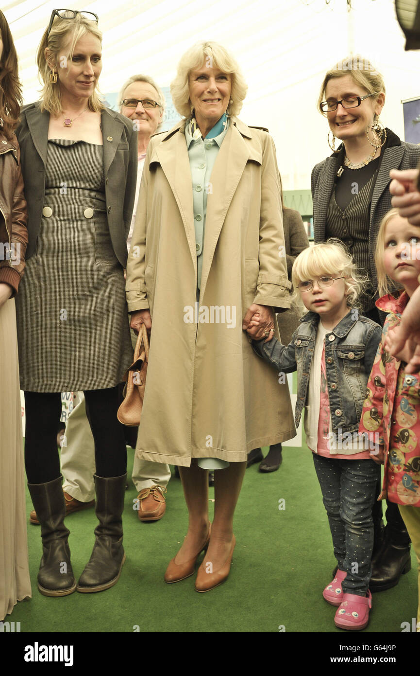 The Duchess of Cornwall holds hands with three year old Isobel Pearce ...