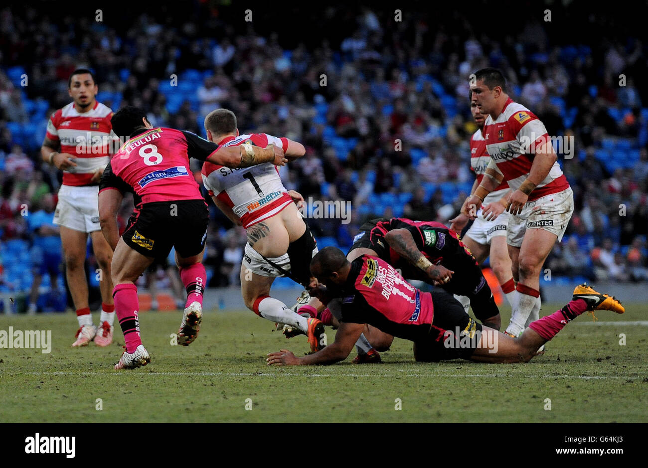 Wigan Warriors' Sam Tomkins loses his shorts in a tackle from Leeds ...