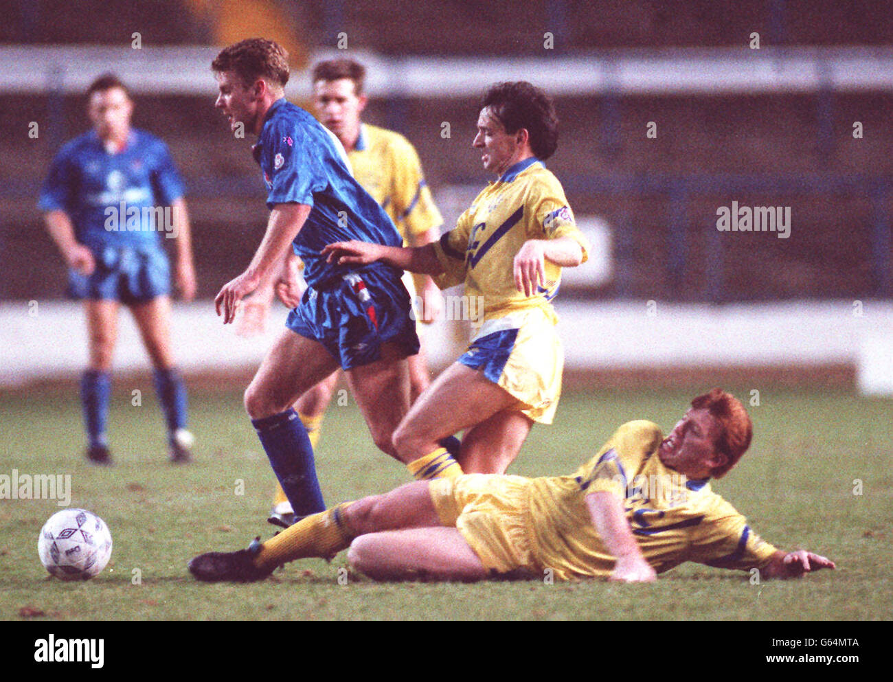 Everton's Stuart McCall (ground) and Pat Nevin just fail to tackle ...