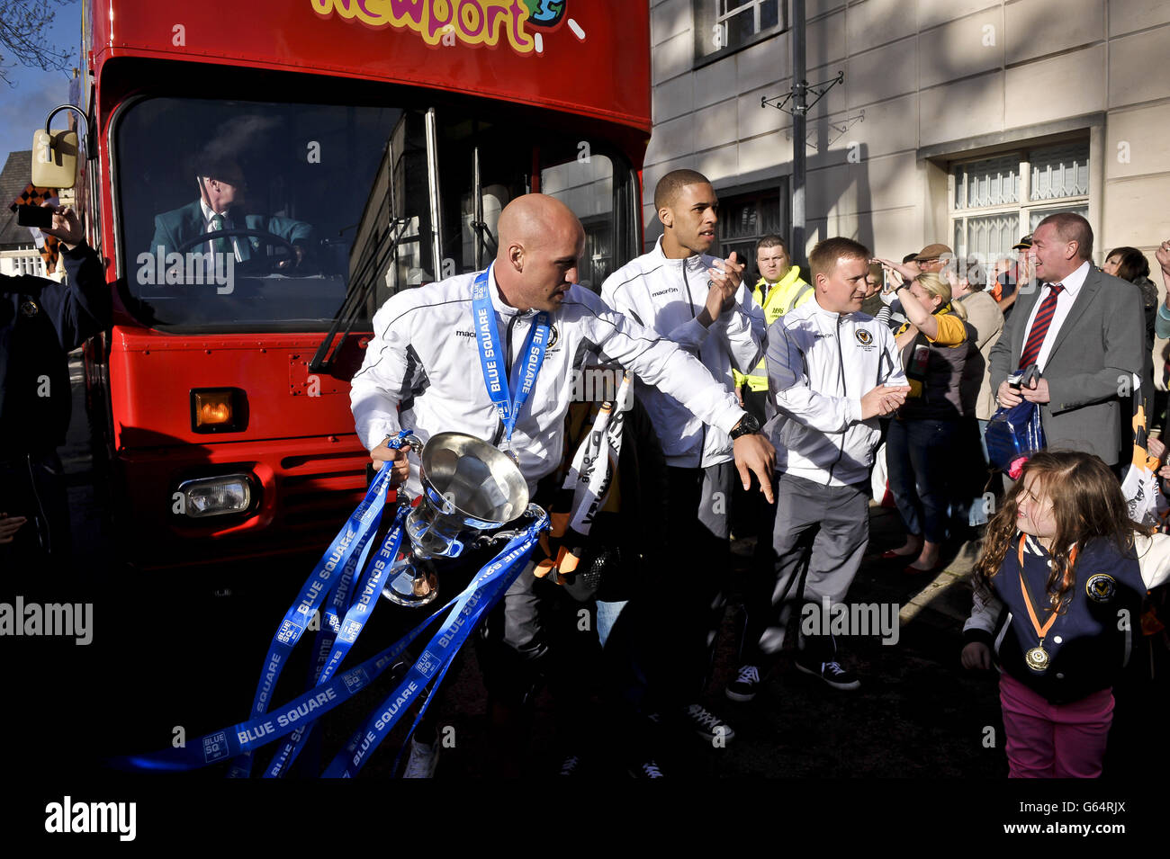 Newport county afc football team players disembark the open top bus hi ...