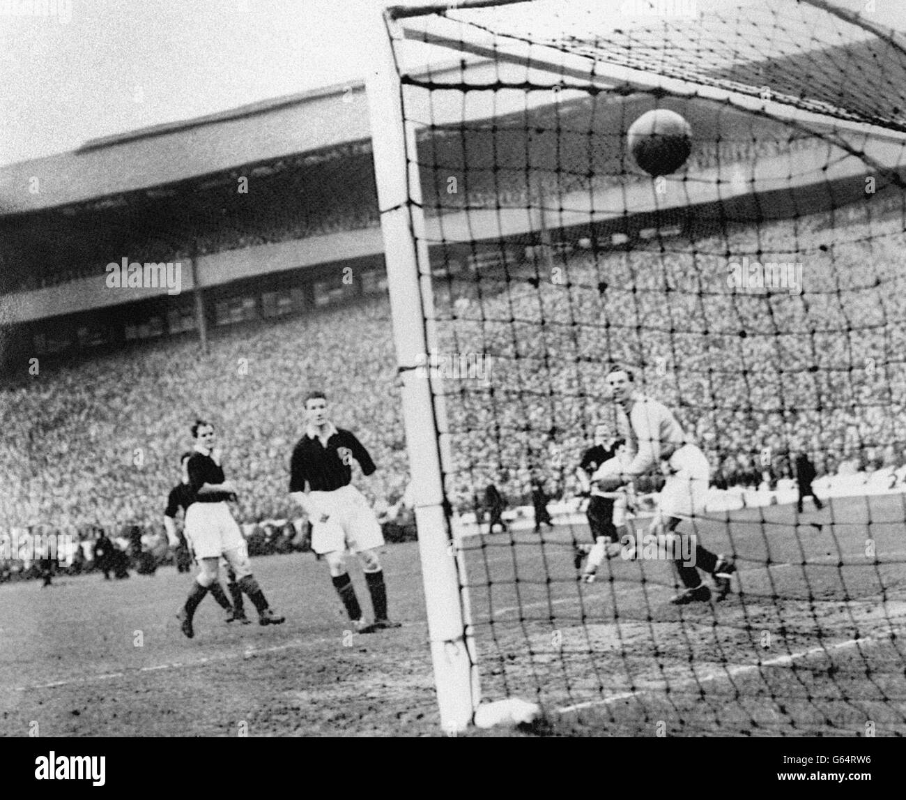 Watched by Scotland goalkeeper Brown (Glasgow Rangers), the ball sails ...