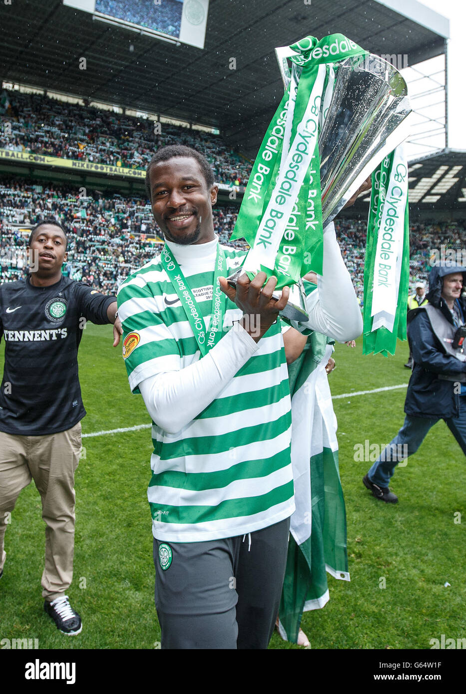 Celtic's Efe Ambrose parades the SPL trophy on the pitch after the ...