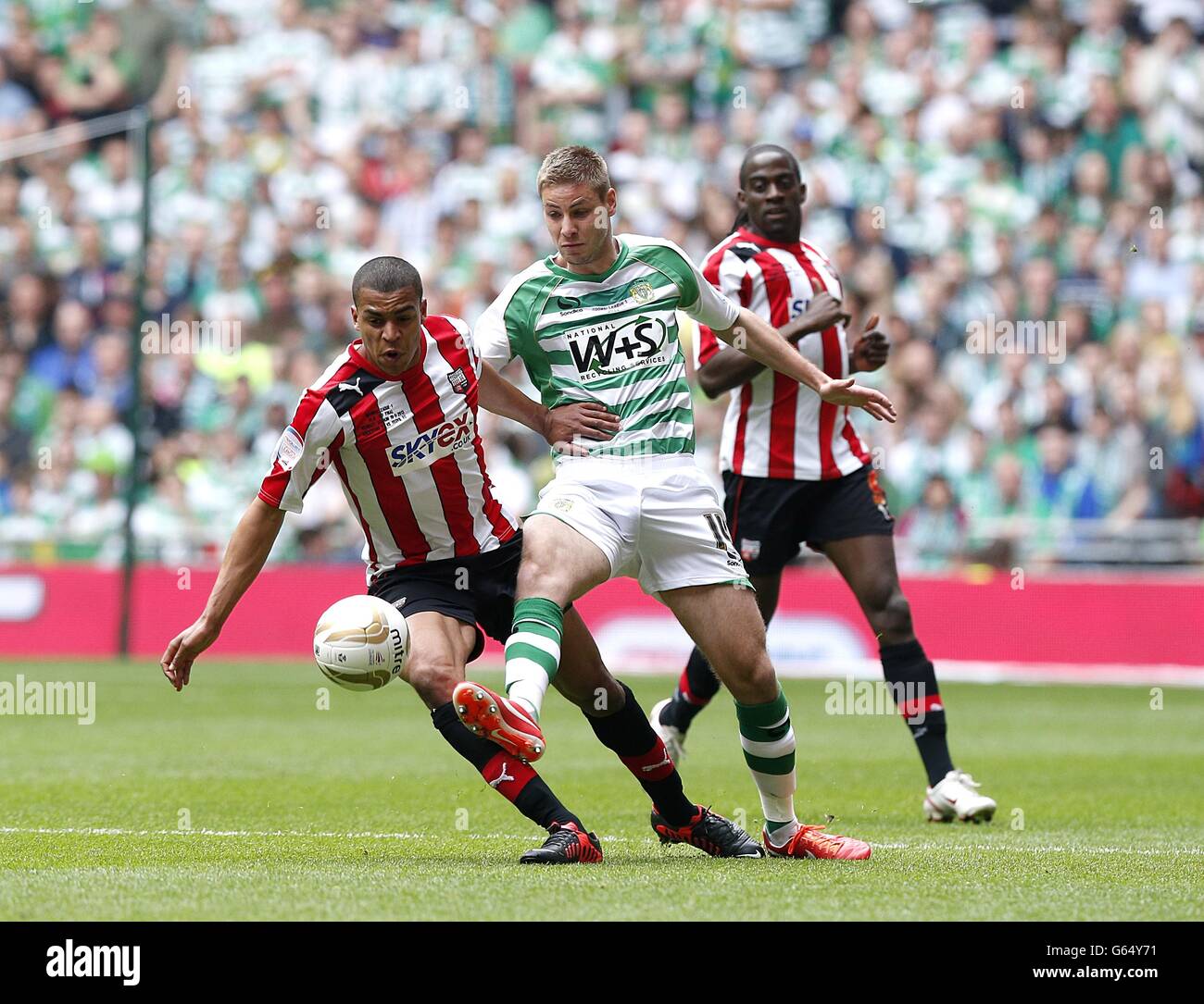 Brentford's Tom Adeyemi (left) and Yeovil Town's Sam Foley battle for ...