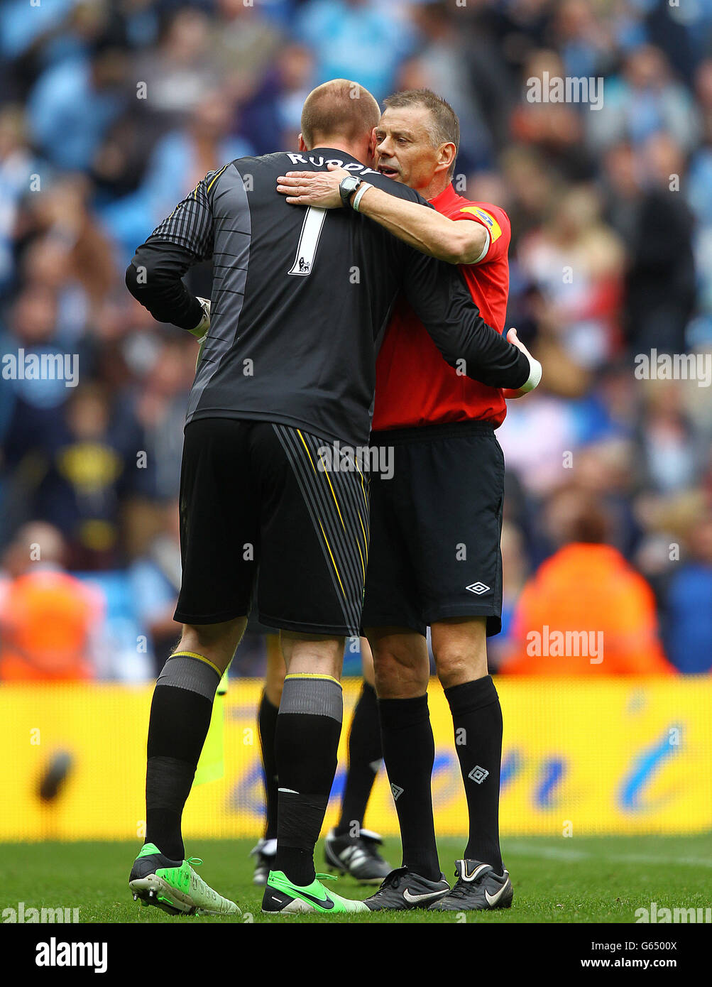 Referee Mark Halsey gets a hug from Norwich City's keeper John Ruddy at ...