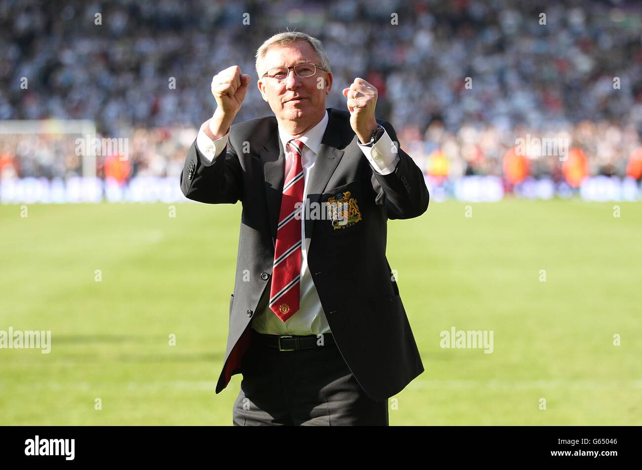 Manchester United manager Sir Alex Ferguson acknowledges the fans after ...