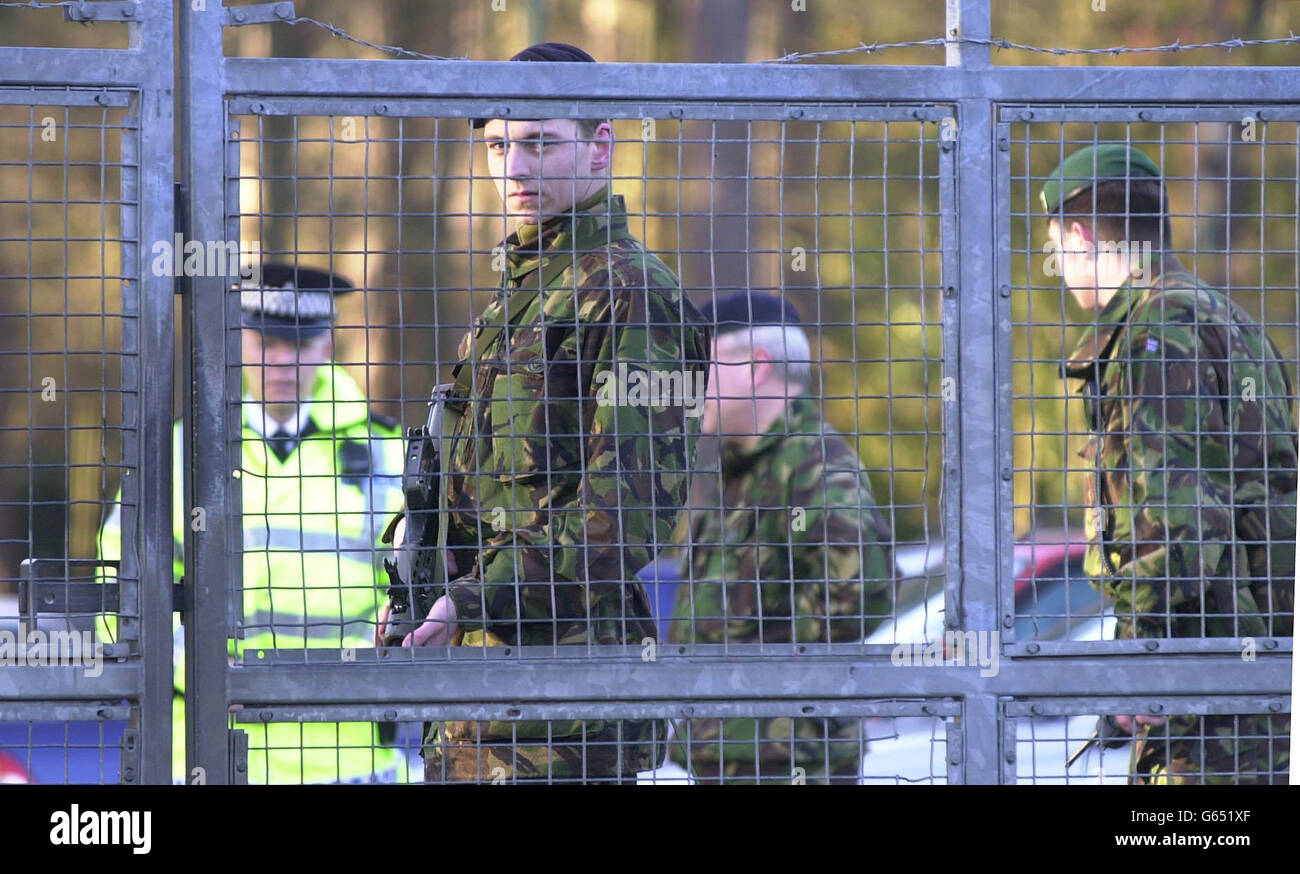Soldiers guard the gate at Deepcut army barracks in Surrey, which is ...