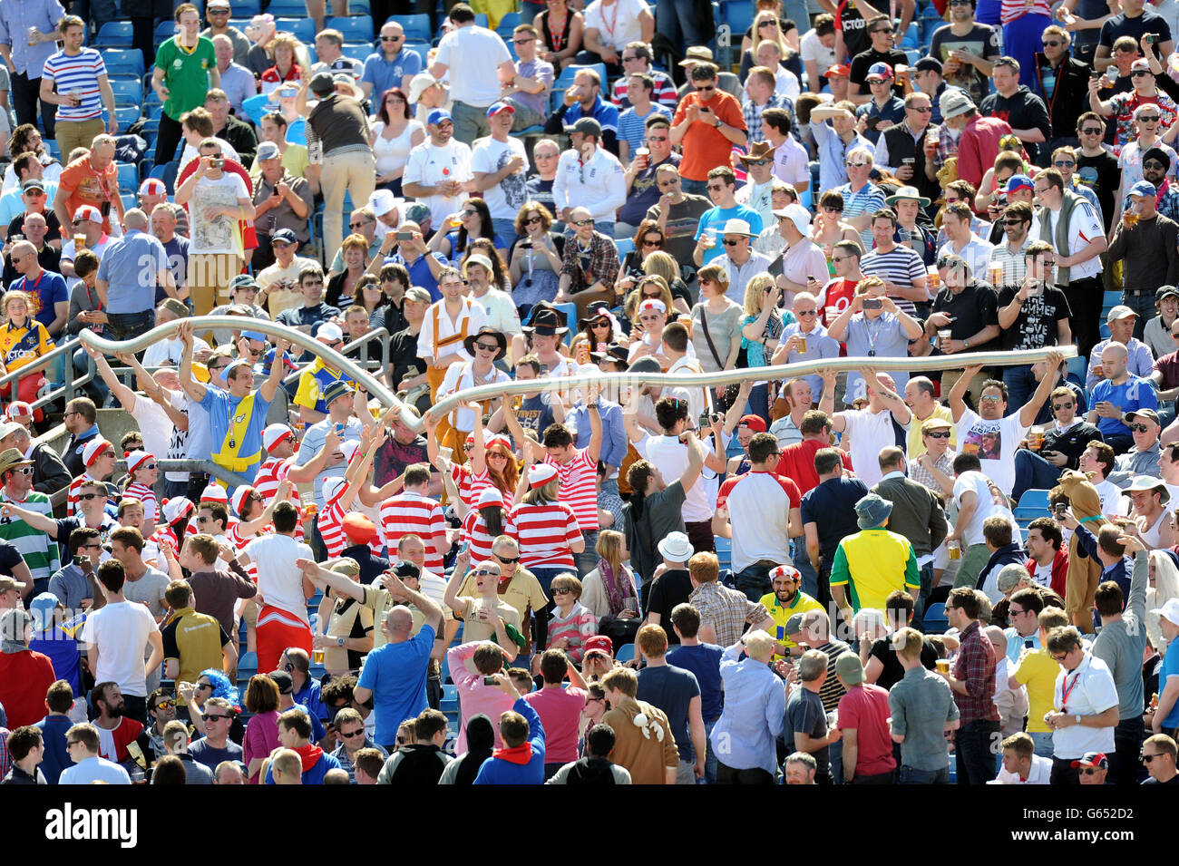 England fans in the western terrace hold up a plastic pint stack during ...