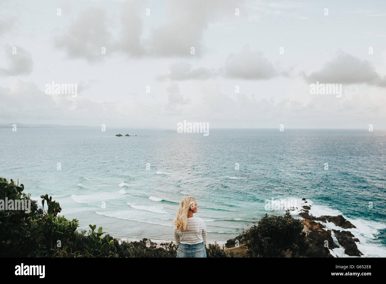 Woman enjoying the ocean view Stock Photo - Alamy