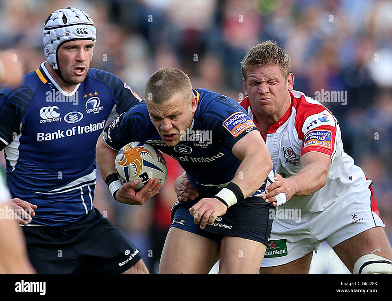 Leinster's Ian Madigan evades a tackle from Ulster's Chris Henry during ...