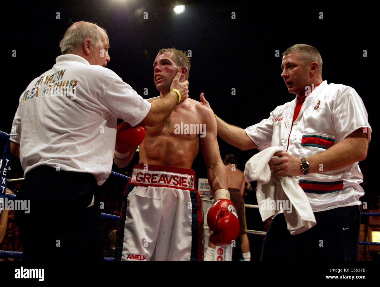 Challenger Carl Greaves in consoled by his cornermen after champion ...