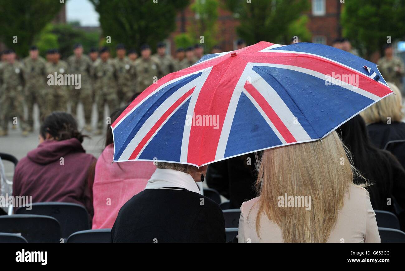 Families shelter from the rain as the Princess Royal meets and presents ...