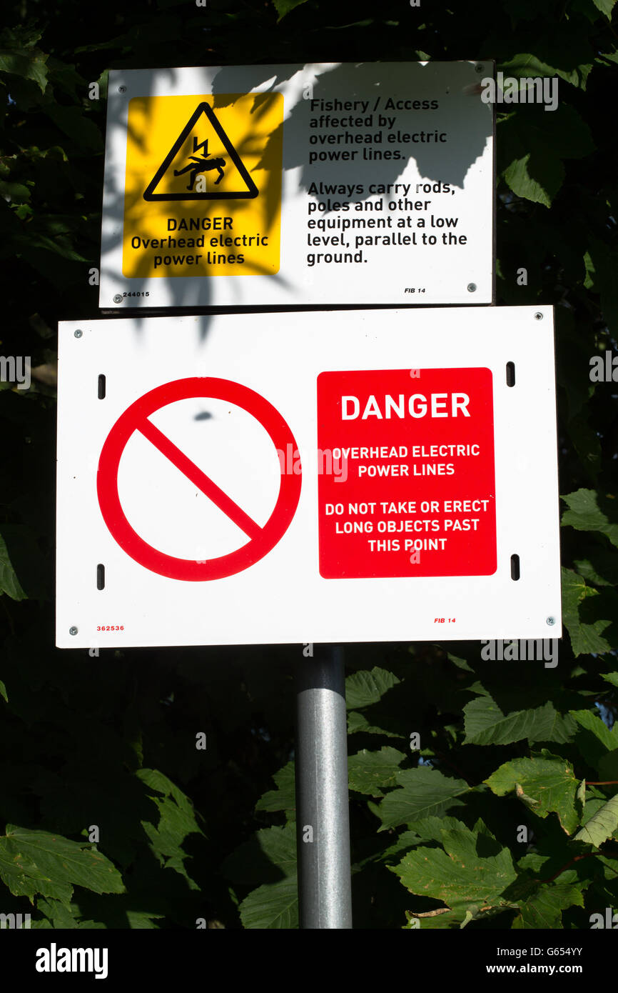 A "Danger, Overhead Power Cable" public warning sign posted below ...