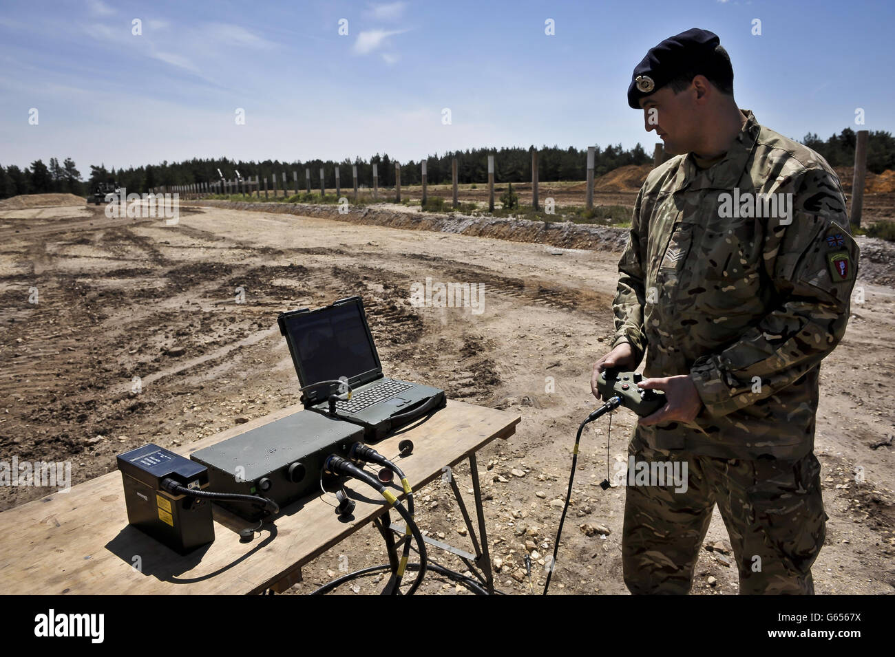 A soldier uses a games consol style controller to control a Terrier ...