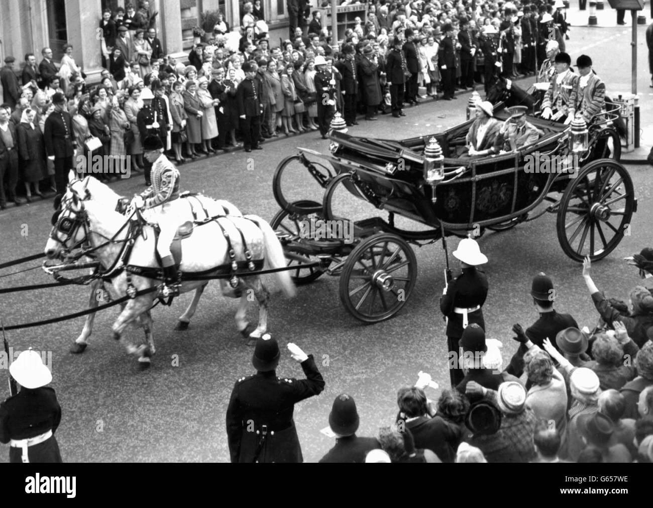 A Royal Marines street-liner smartly presents arms as the Queen and ...