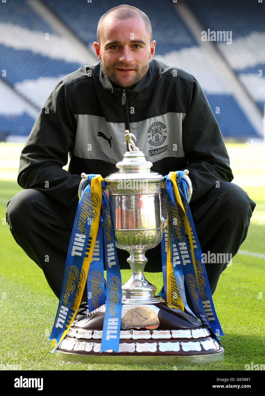 Hibernian captain James McPake poses with the William Hill Scottish Cup ...