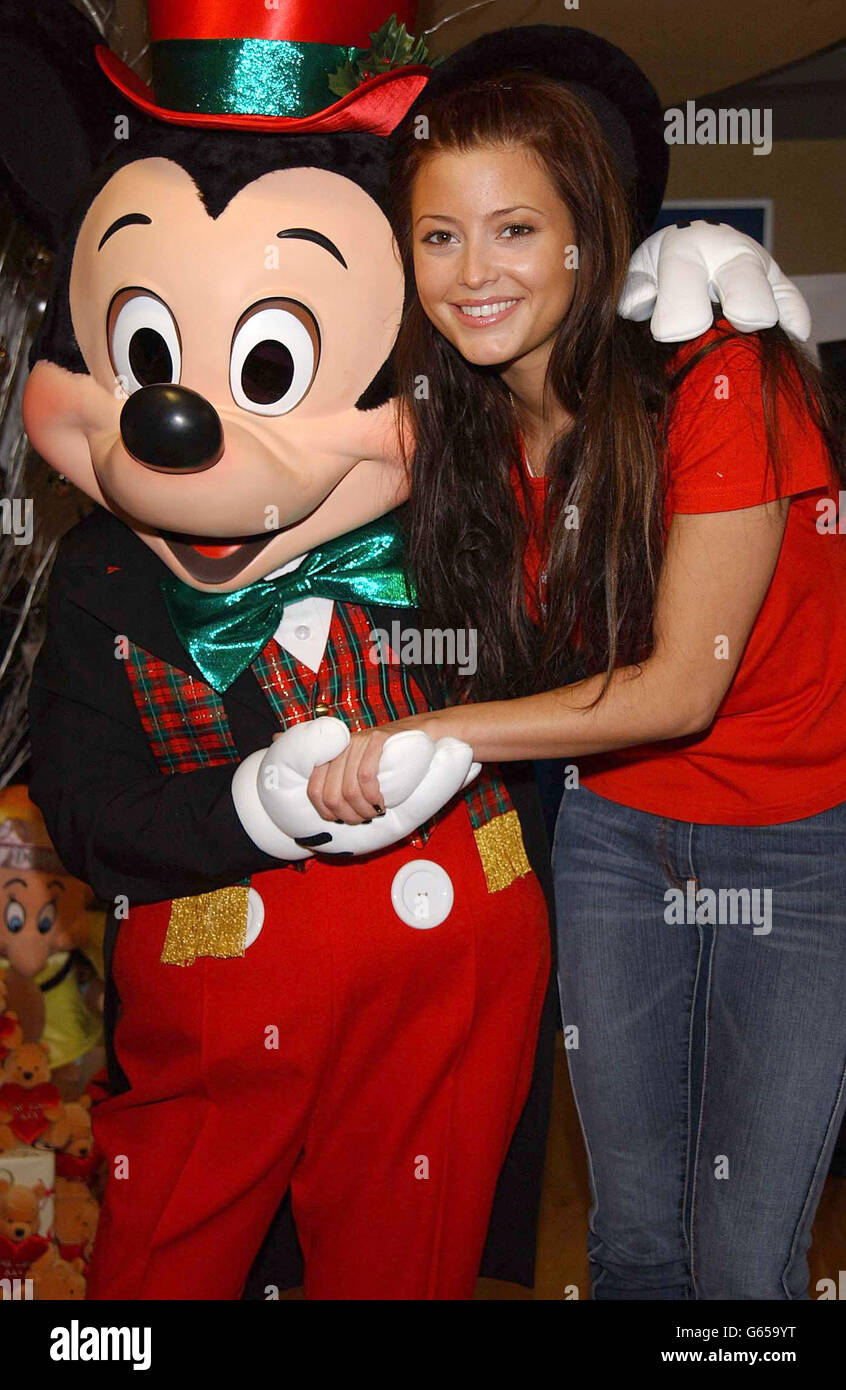Australian singer Holly Valance cuddles up to Mickey Mouse during a ...