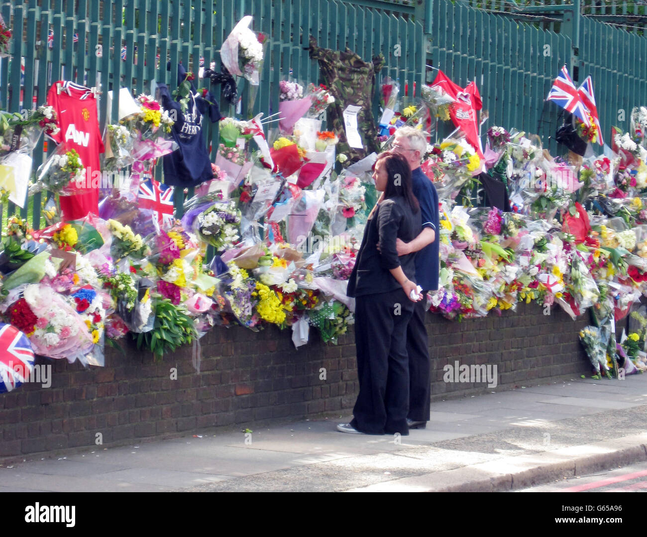 Drummer Lee Rigby's family members look at floral tributes outside ...
