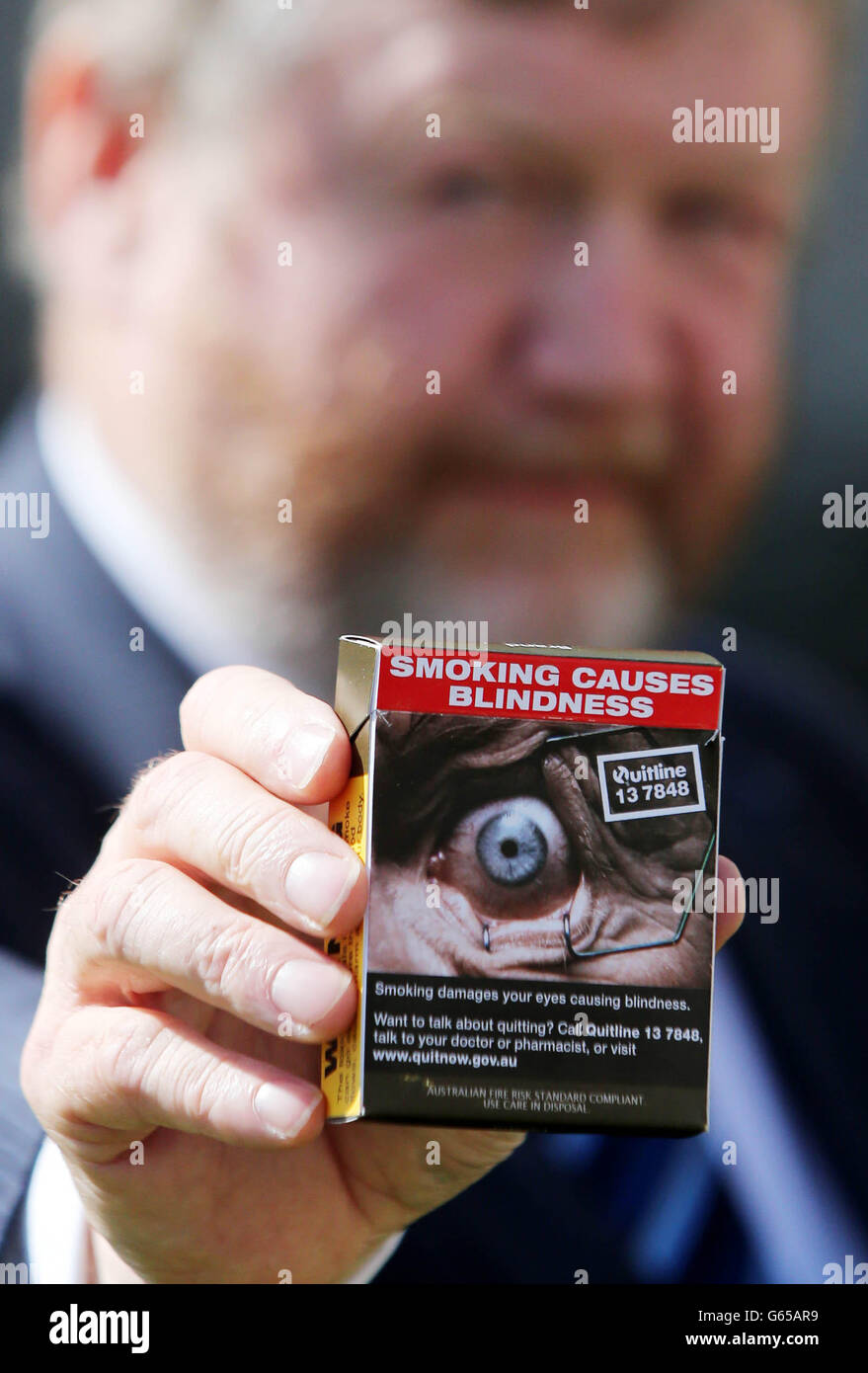 Irish Health Minister James Reilly holds examples of plain pack ...