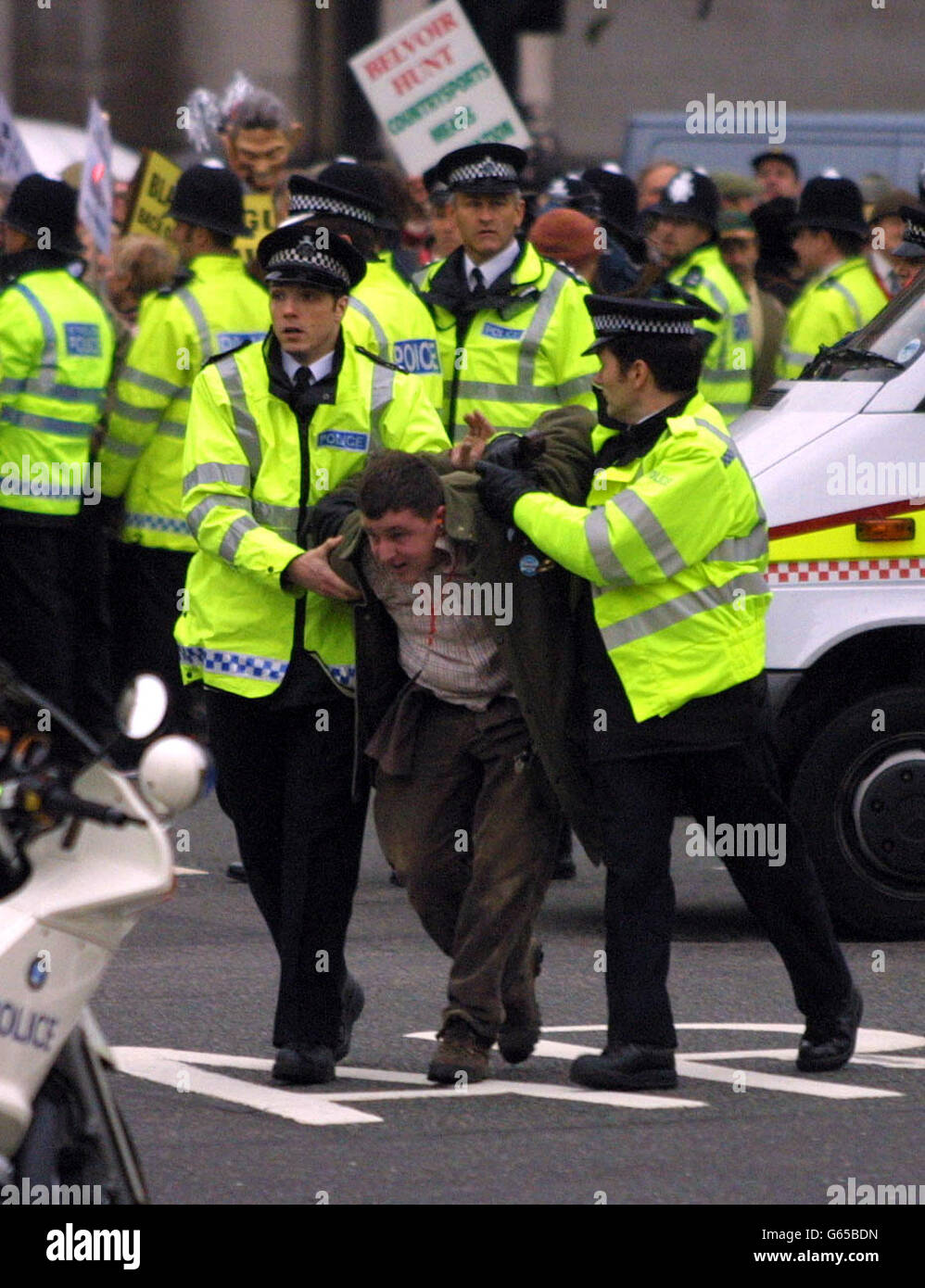 Police officers restrain a demonstrator in Parliament Square during a ...