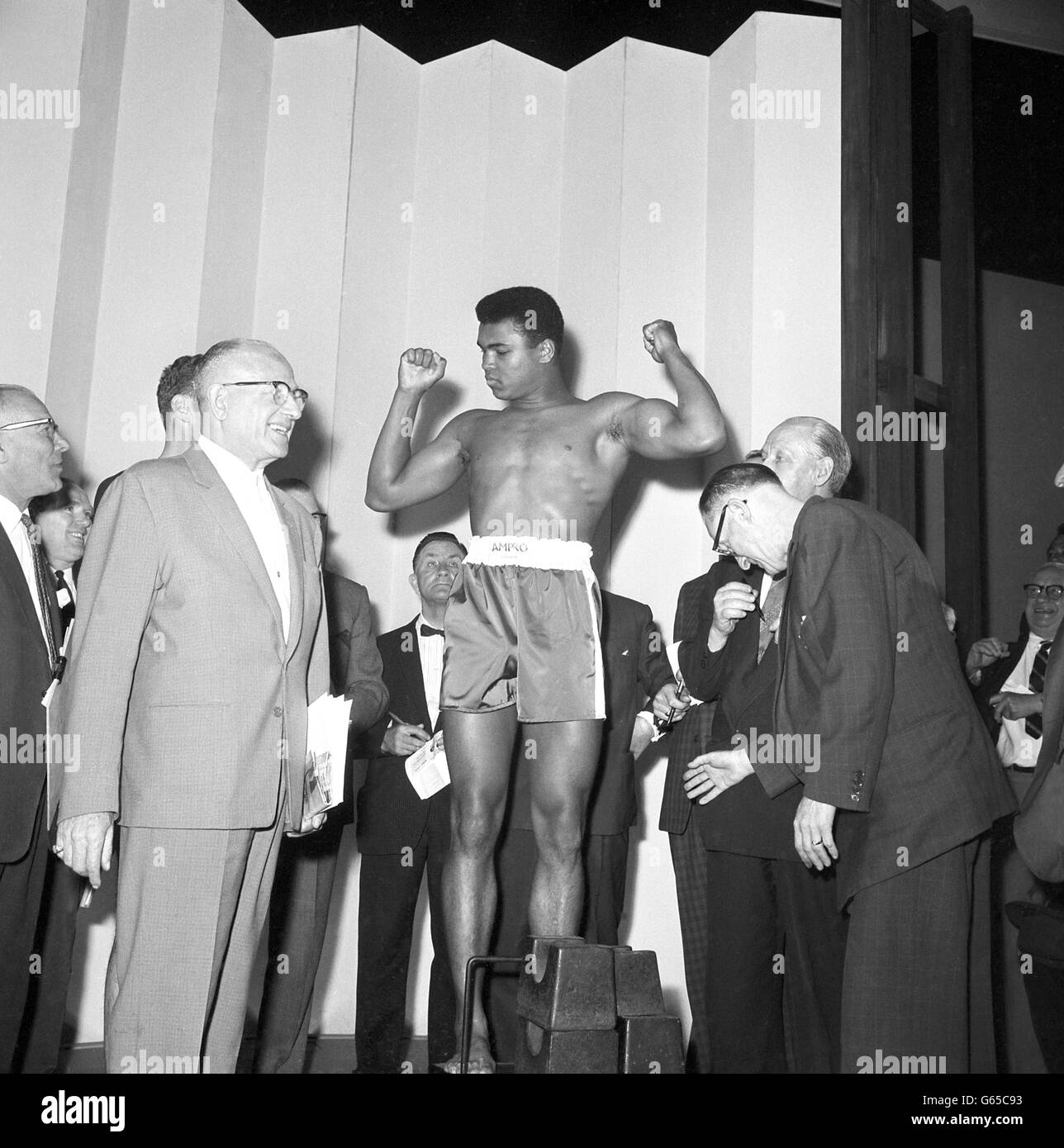 American heavyweight Cassius Clay on the scales during the weigh-in at ...
