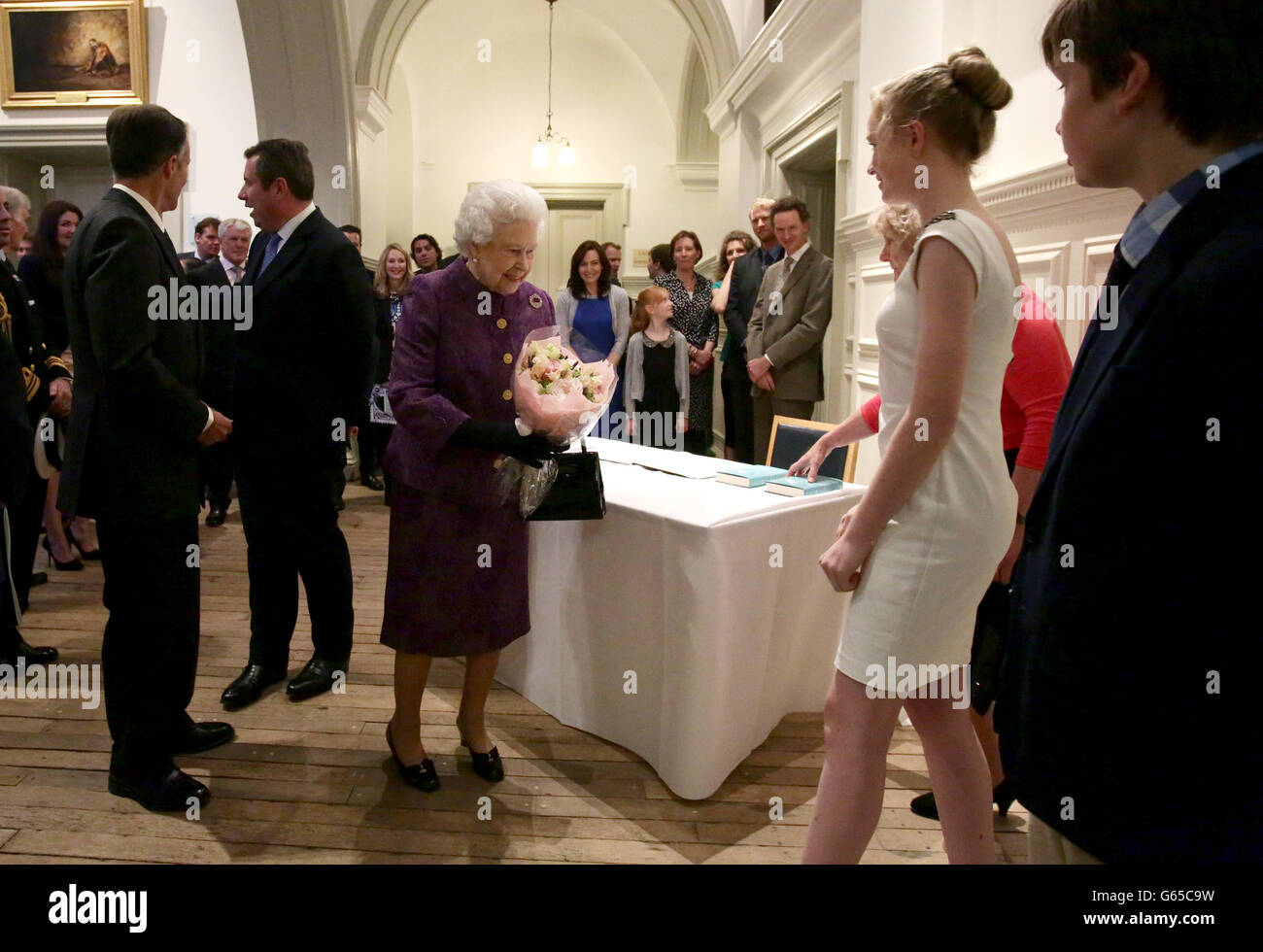 Queen Elizabeth II after being presented with flowers by a relative of ...