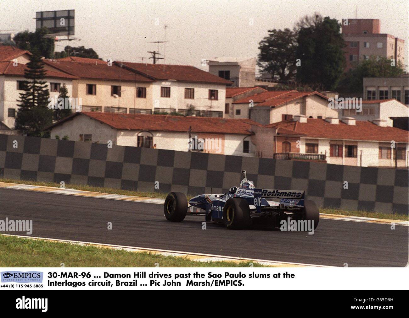 Damon Hill drives past the Sao Paulo slums at the Interlagos circuit ...