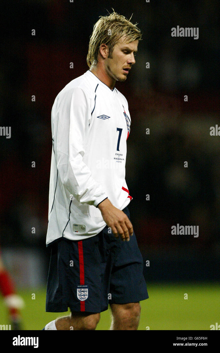 Dejected England captain David Beckham walks off the pitch after ...