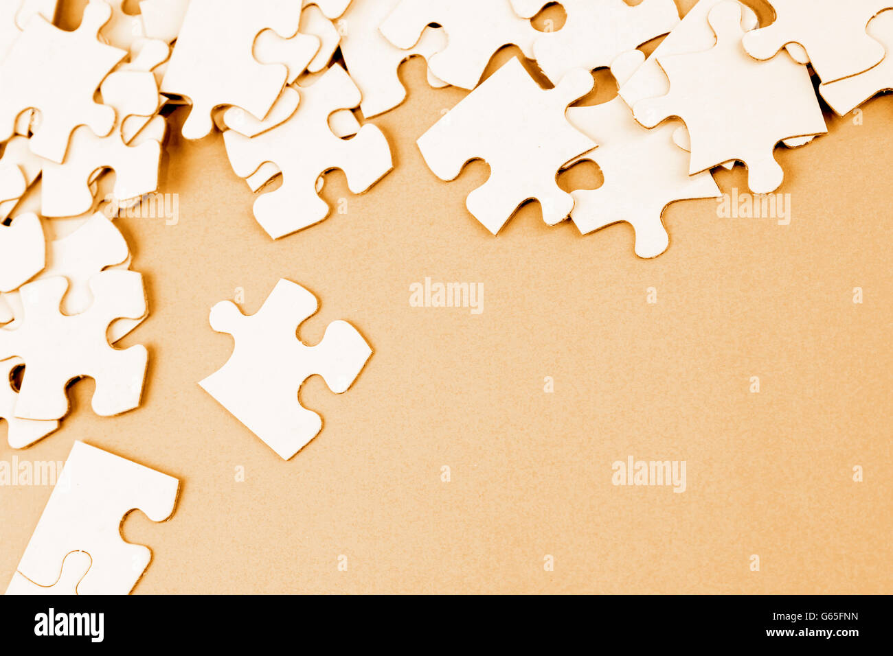Loose jigsaw puzzle pieces on brown background Stock Photo - Alamy