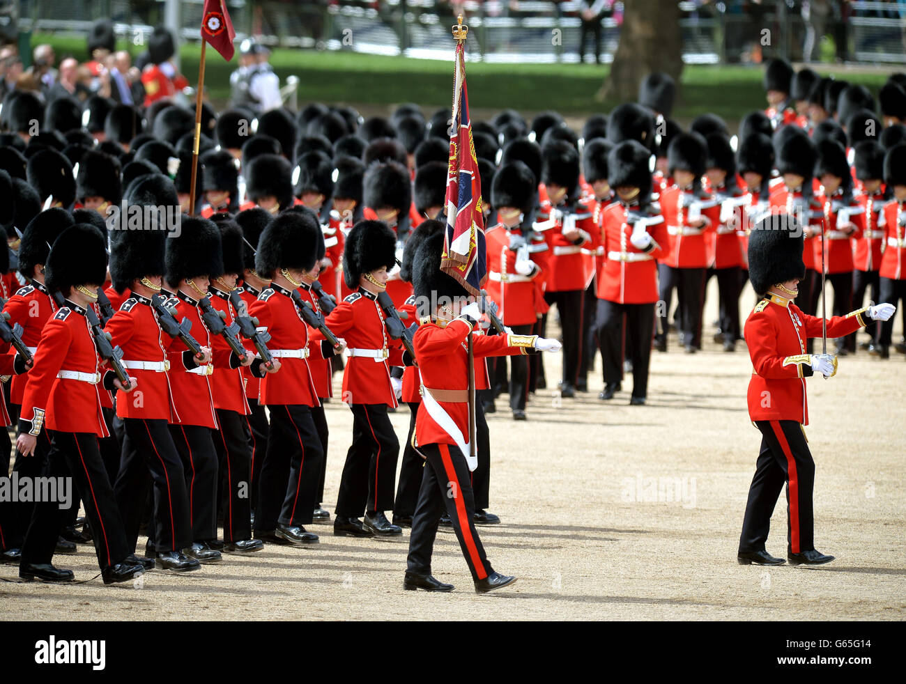 Trooping the Colour as it is passed in front of the Guards Regiments ...