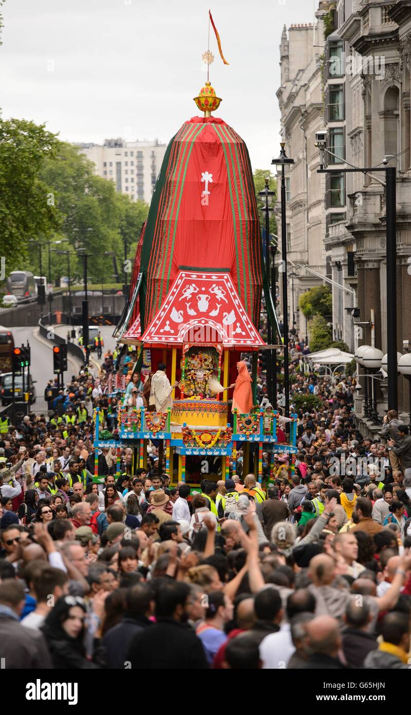 Three 40-foot high chariots process along Picadilly in central London ...