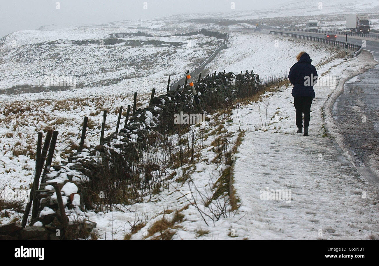 A woman walks through the snow near Bowes in the North Pennines Stock ...