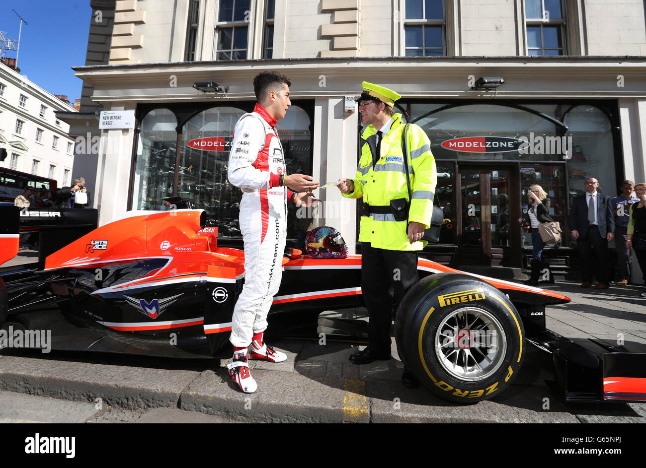 s New Oxford Street, as an actor dressed as a traffic warden clamps his ...