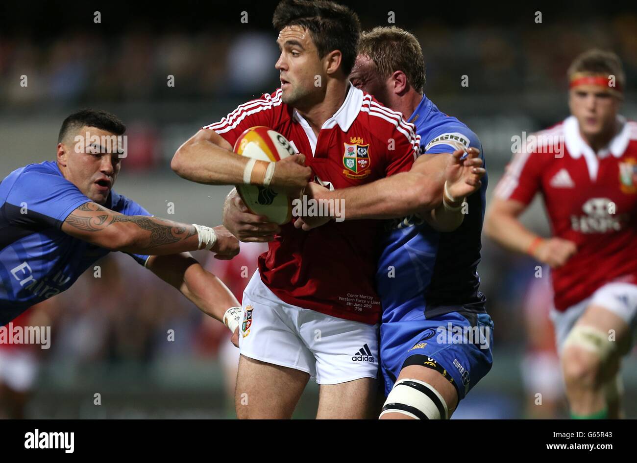 British and Irish Lions' Conor Murray is tackled by Western Force's ...