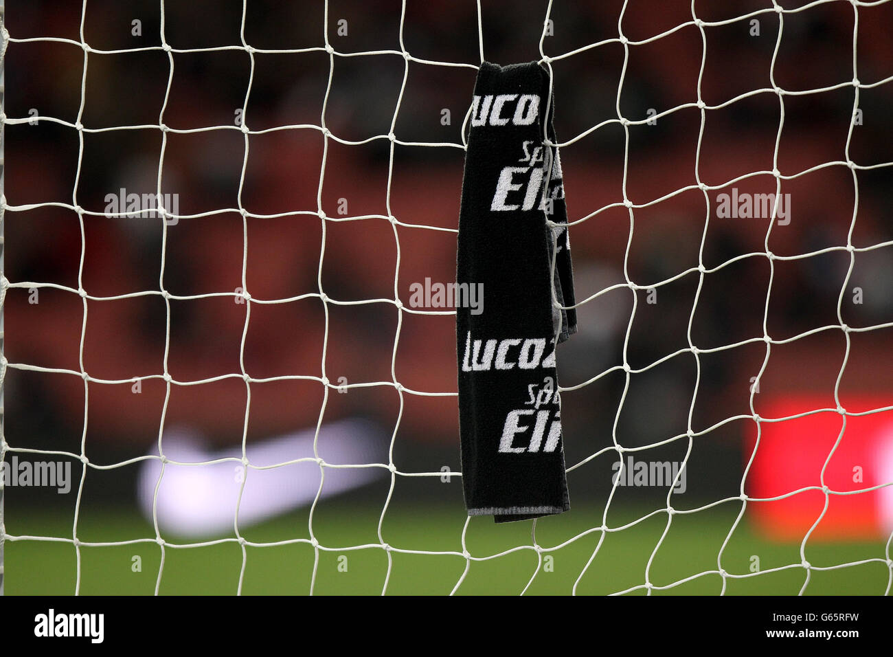 Detail of a Lucozade Sport branded towel hanging in the goal nets at ...