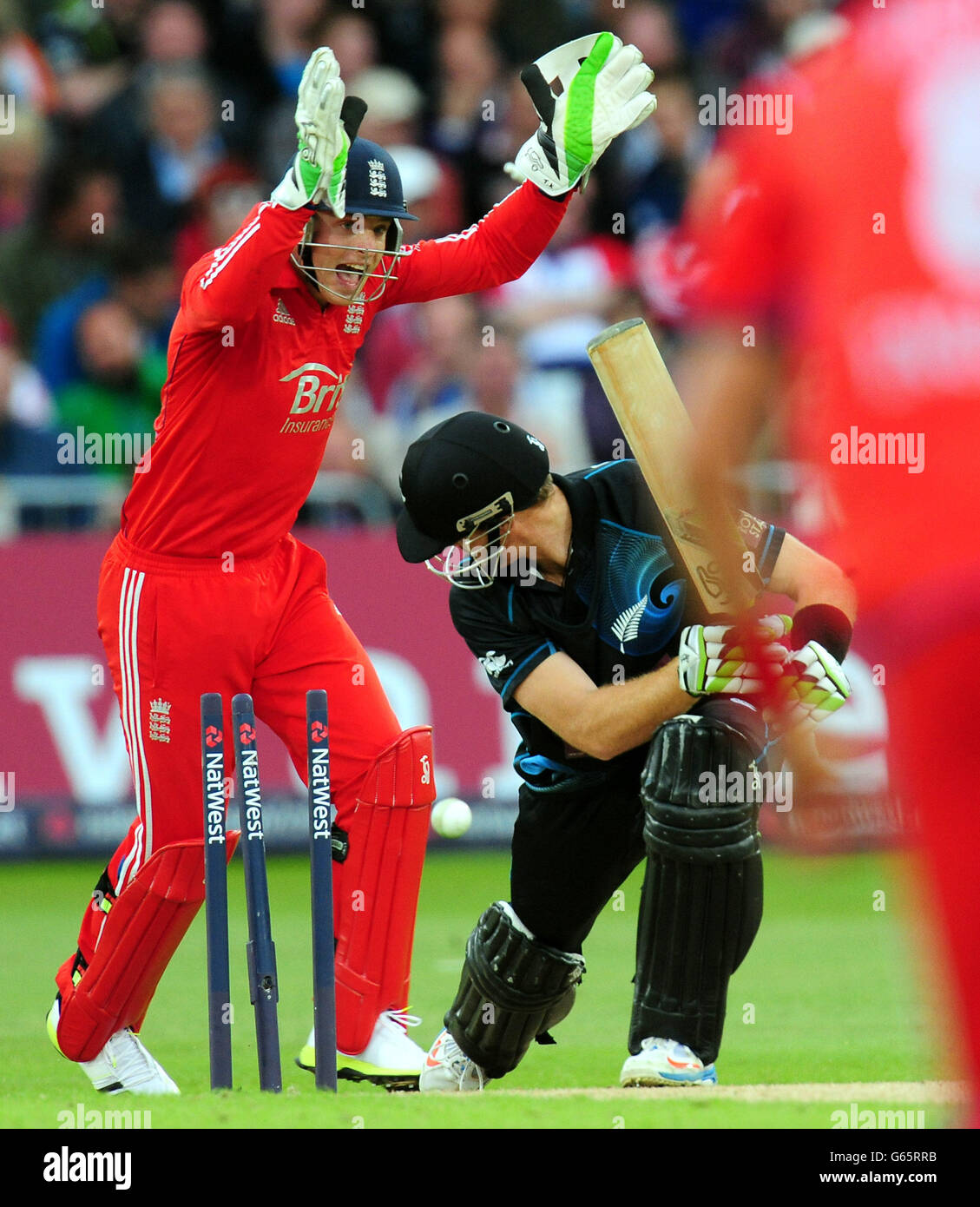 England's wicket keeper Jos Buttler celebrates after James Tredwell ...