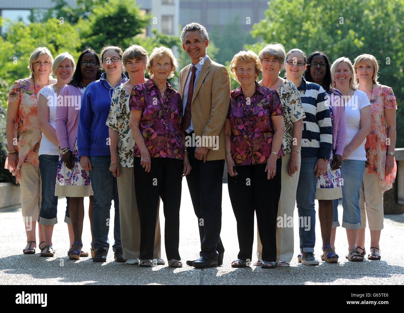 Professor Tim Spector (centre) poses with six sets of twins outside St ...