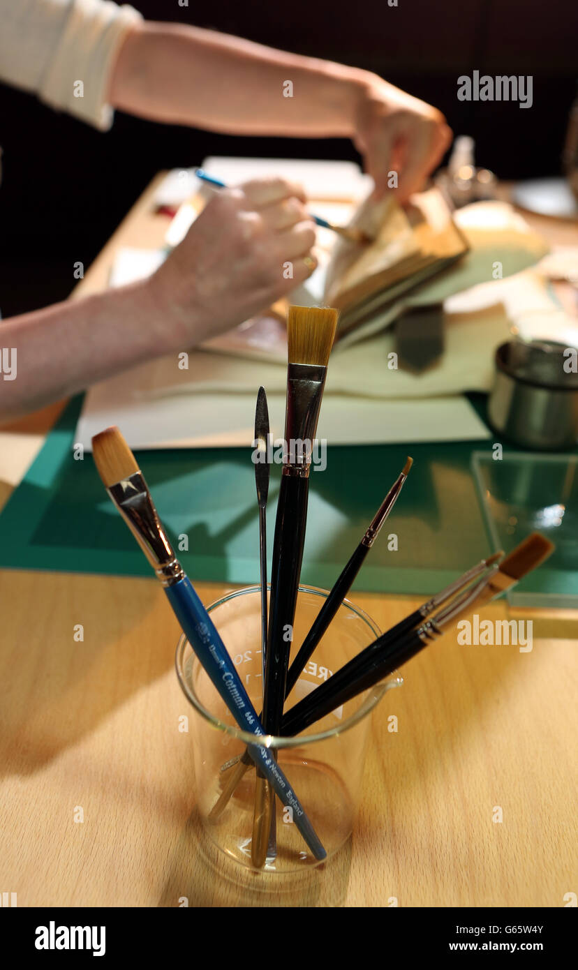 Paper Conservators work on a collection of water stained books in the ...