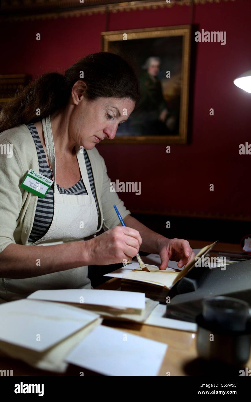 Sara Lennox-Cook, a Paper Conservator, works on a collection of water ...