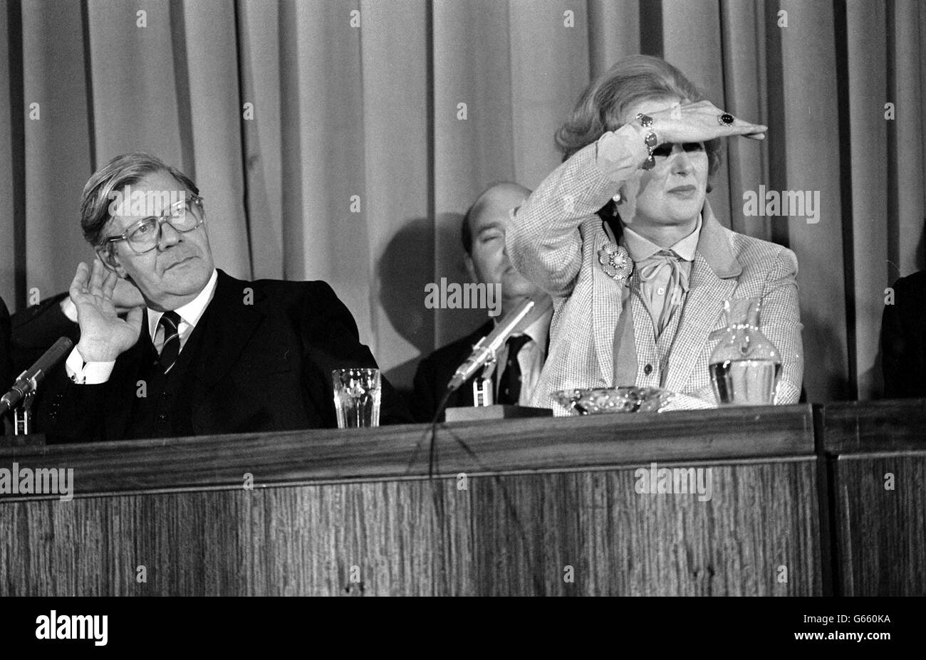 West German Chancellor Herr Helmut Schmidt cups an ear, as Premier Mrs ...
