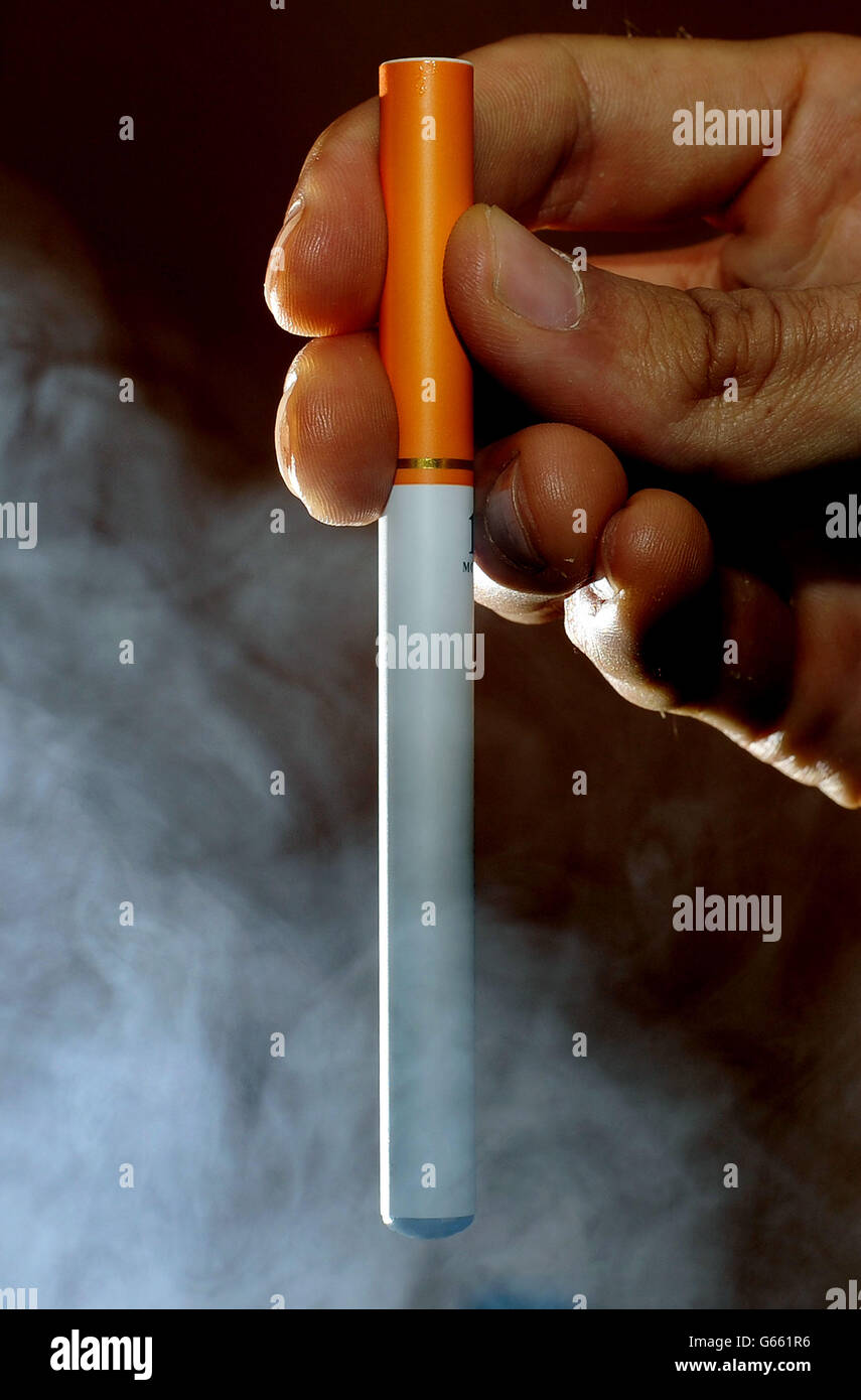 Picture posed by model a person smokes an electronic cigarette hi-res ...