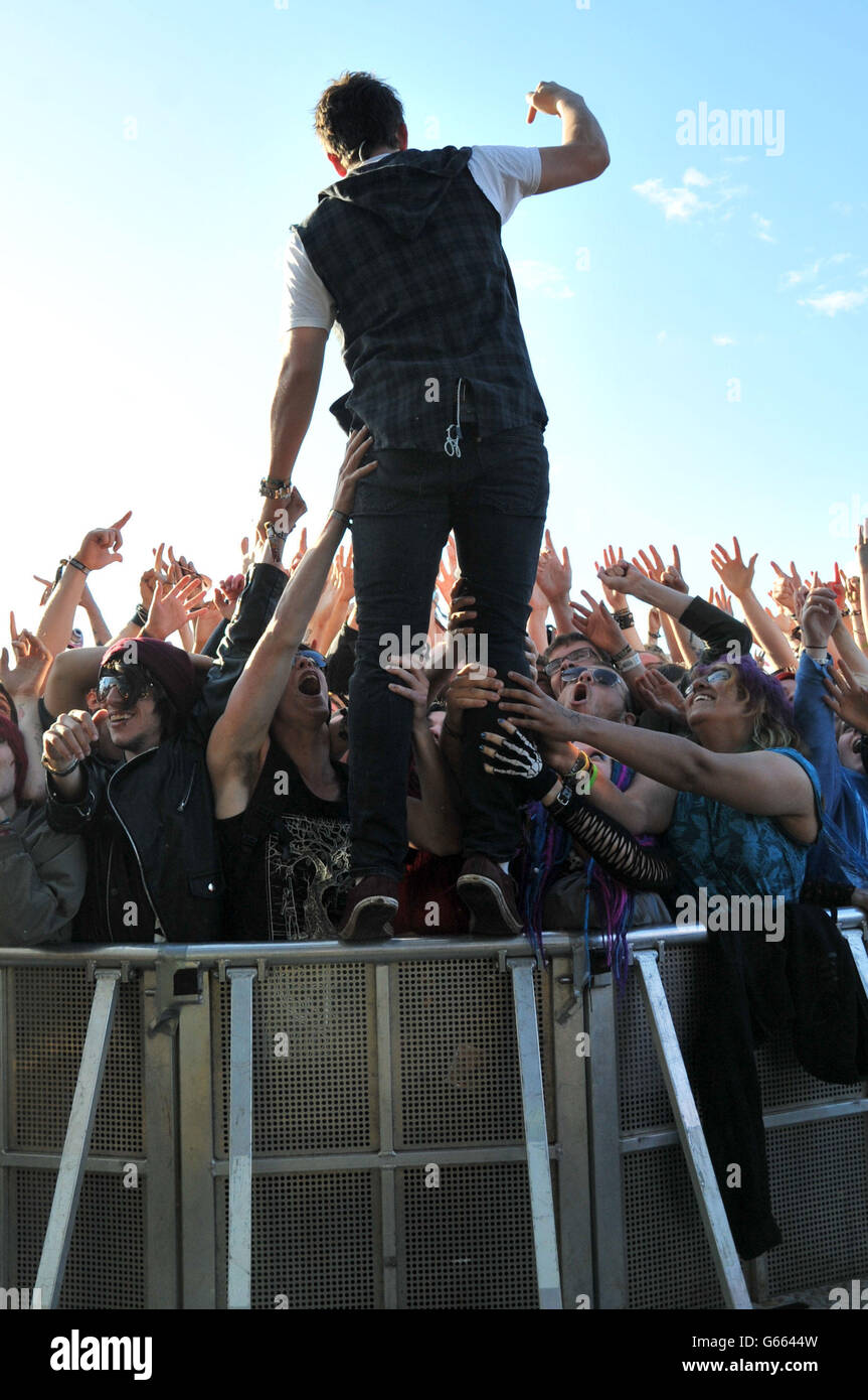 Chris Batten of Enter Shikari stands on the crowd barrier during his ...