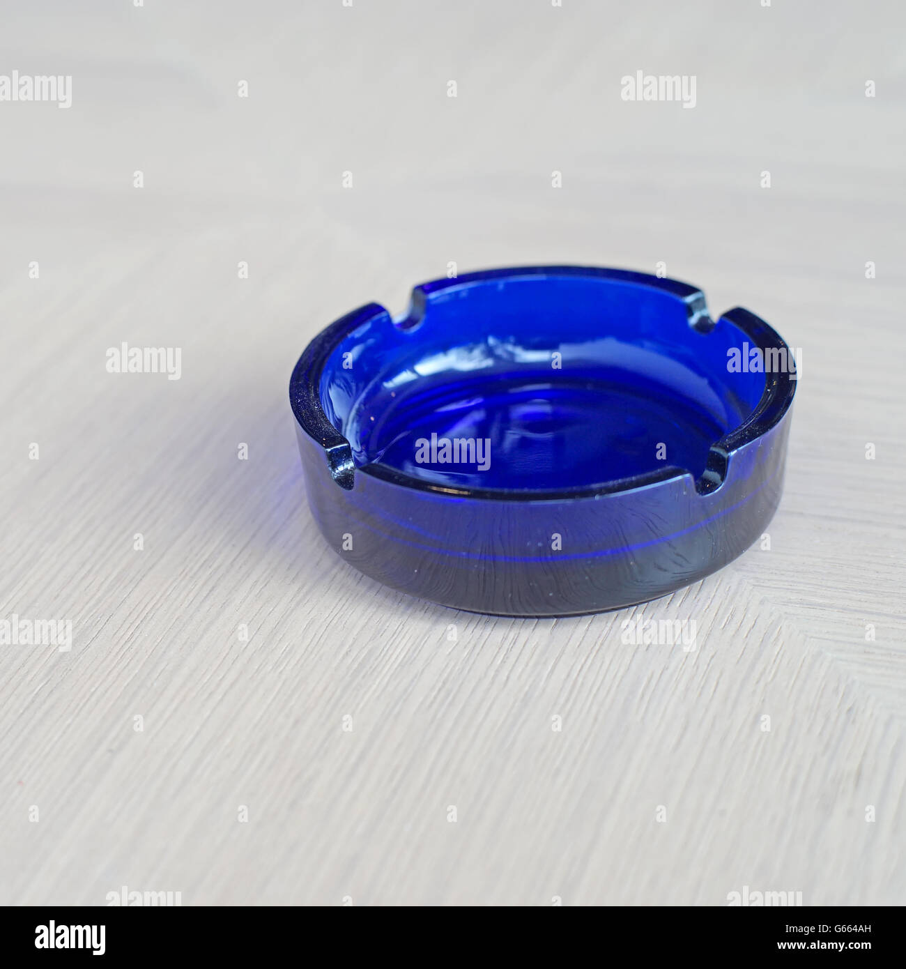 empty blue ashtray on a wooden table Stock Photo - Alamy