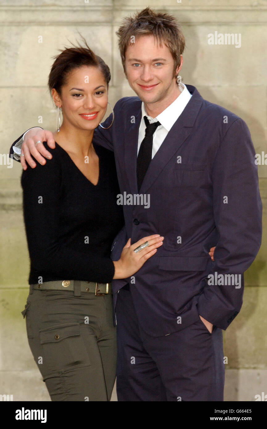 Celebrity television arm around 1 2 half length smiling touching suit ...