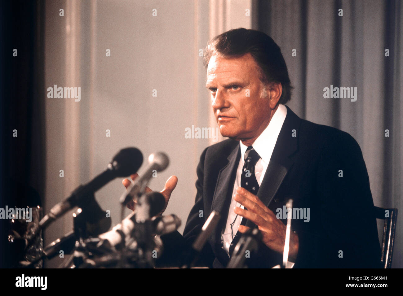 American evangelist Billy Graham speaking at a press conference in ...