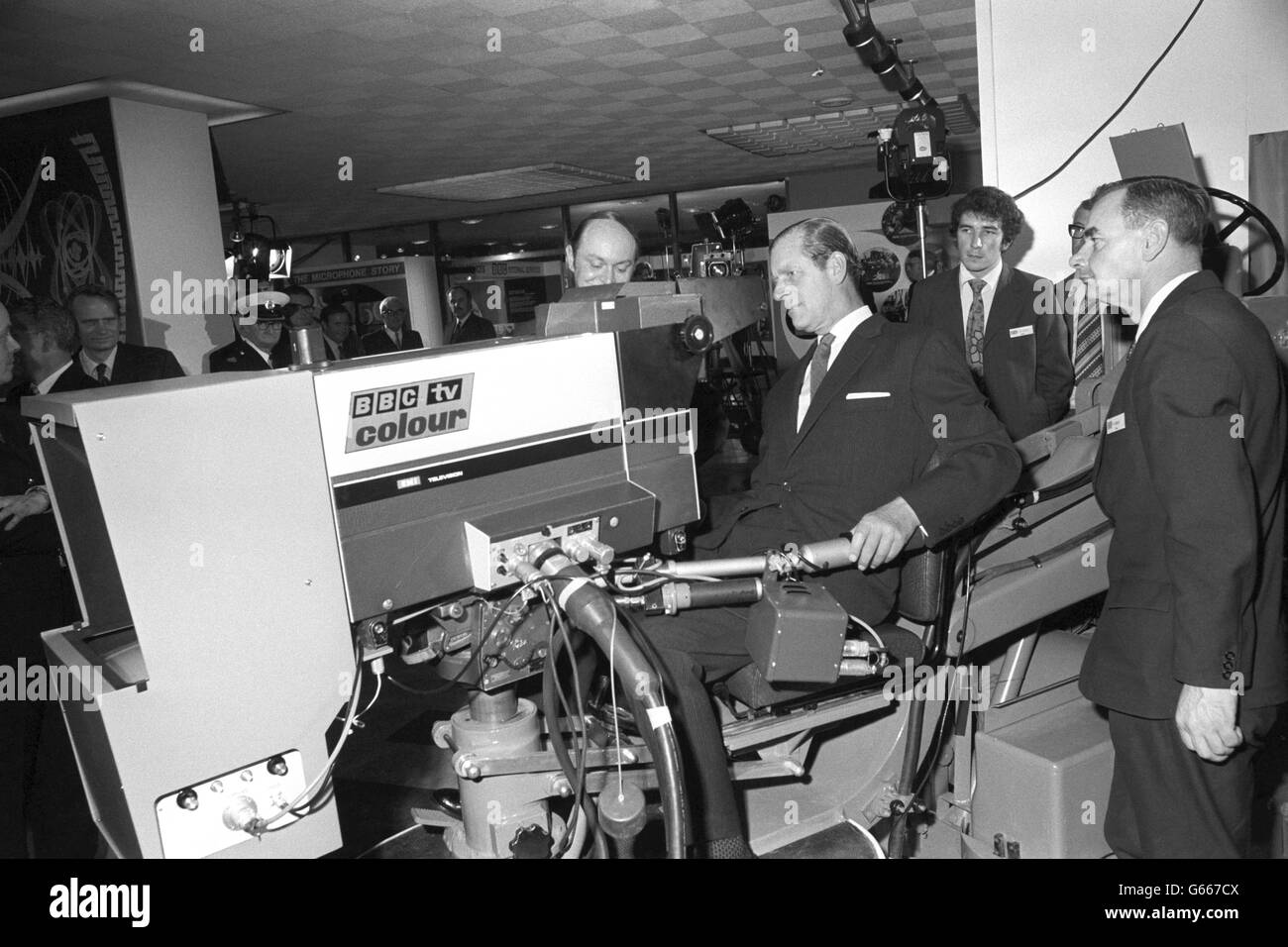 Prince Philip operates a TV camera at Mullard House on a visit to the ...