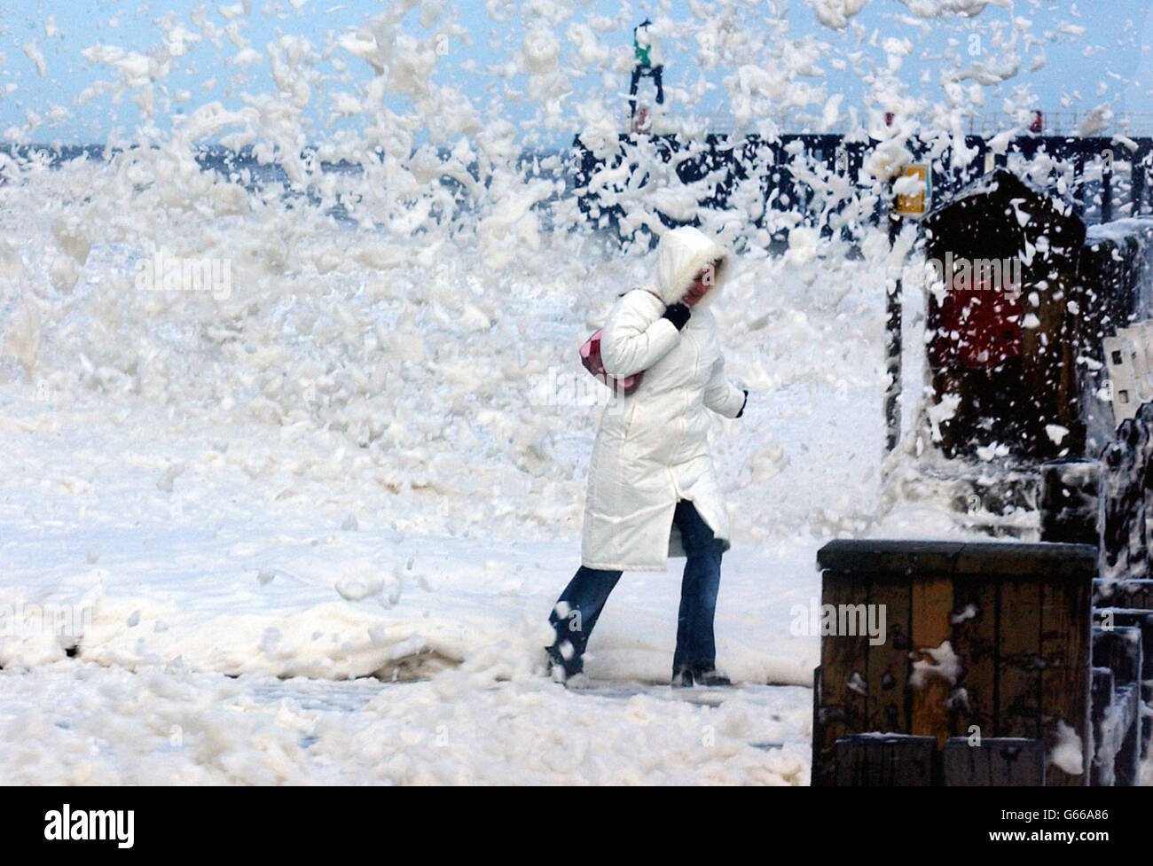 Gale force winds and high seas turn the waves pounding Whitby harbour ...