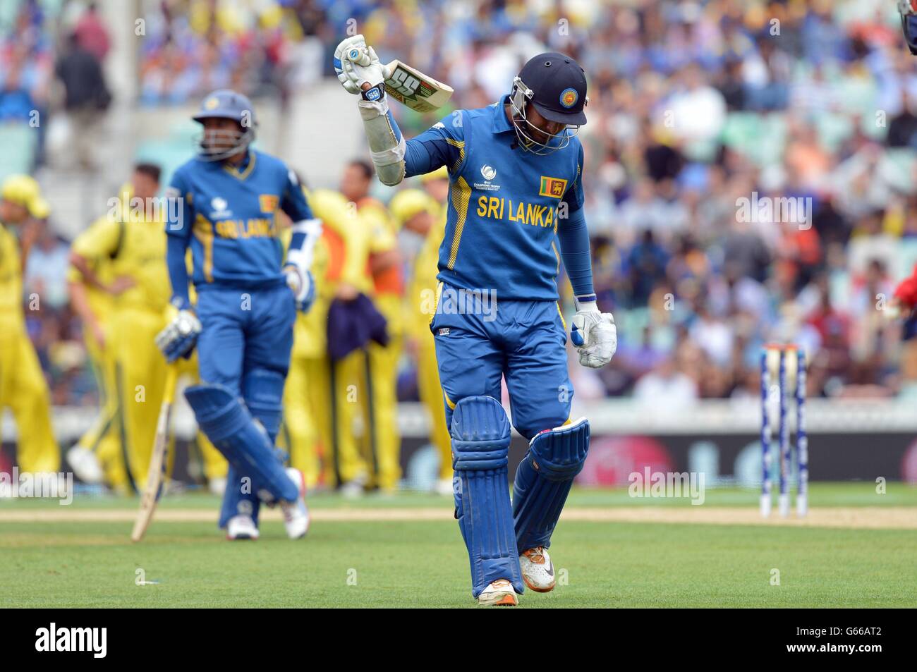 Sri Lanka's Kumar Sangakkara (centre) leaves the field after losing his ...