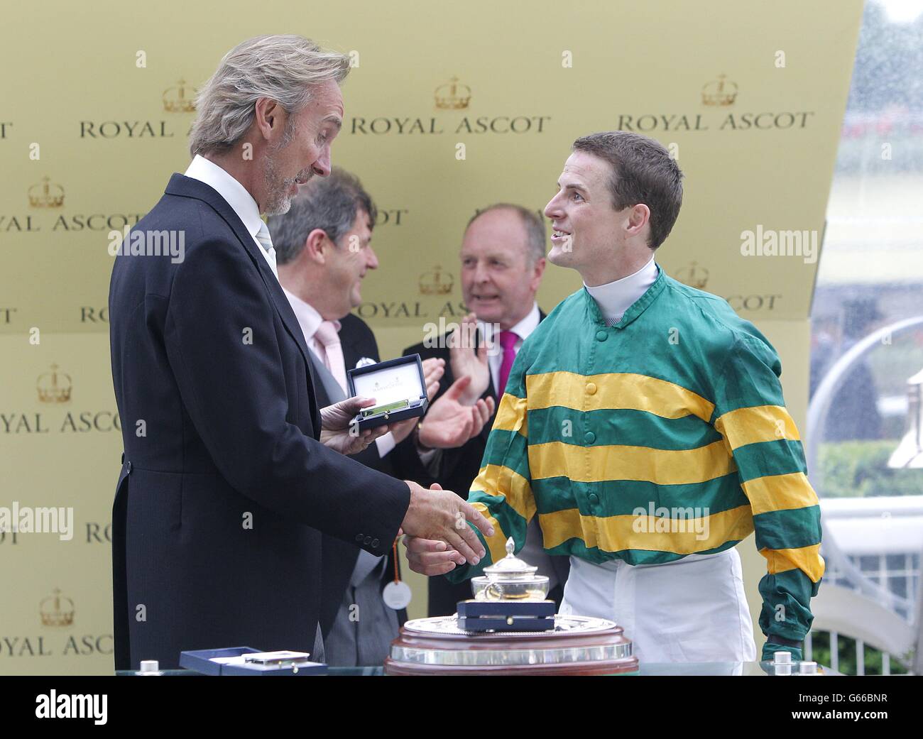Jockey Frank Berry receives the trophy from Mike Rutherford after ...