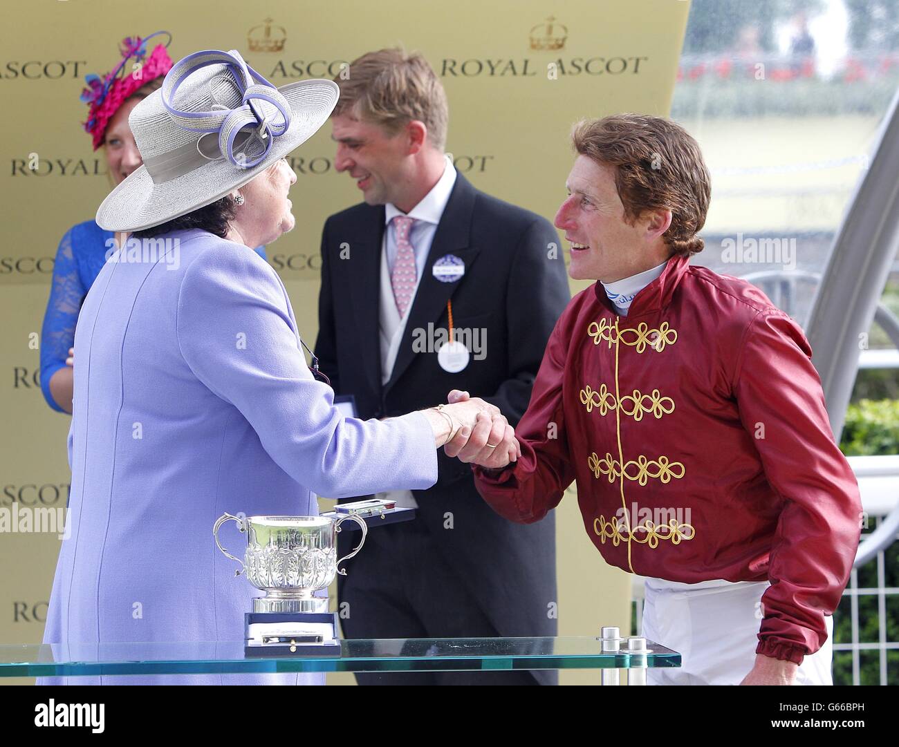 Jockey Johnny Murtagh is awarded his trophy by Lady Rachel Oaksey after ...